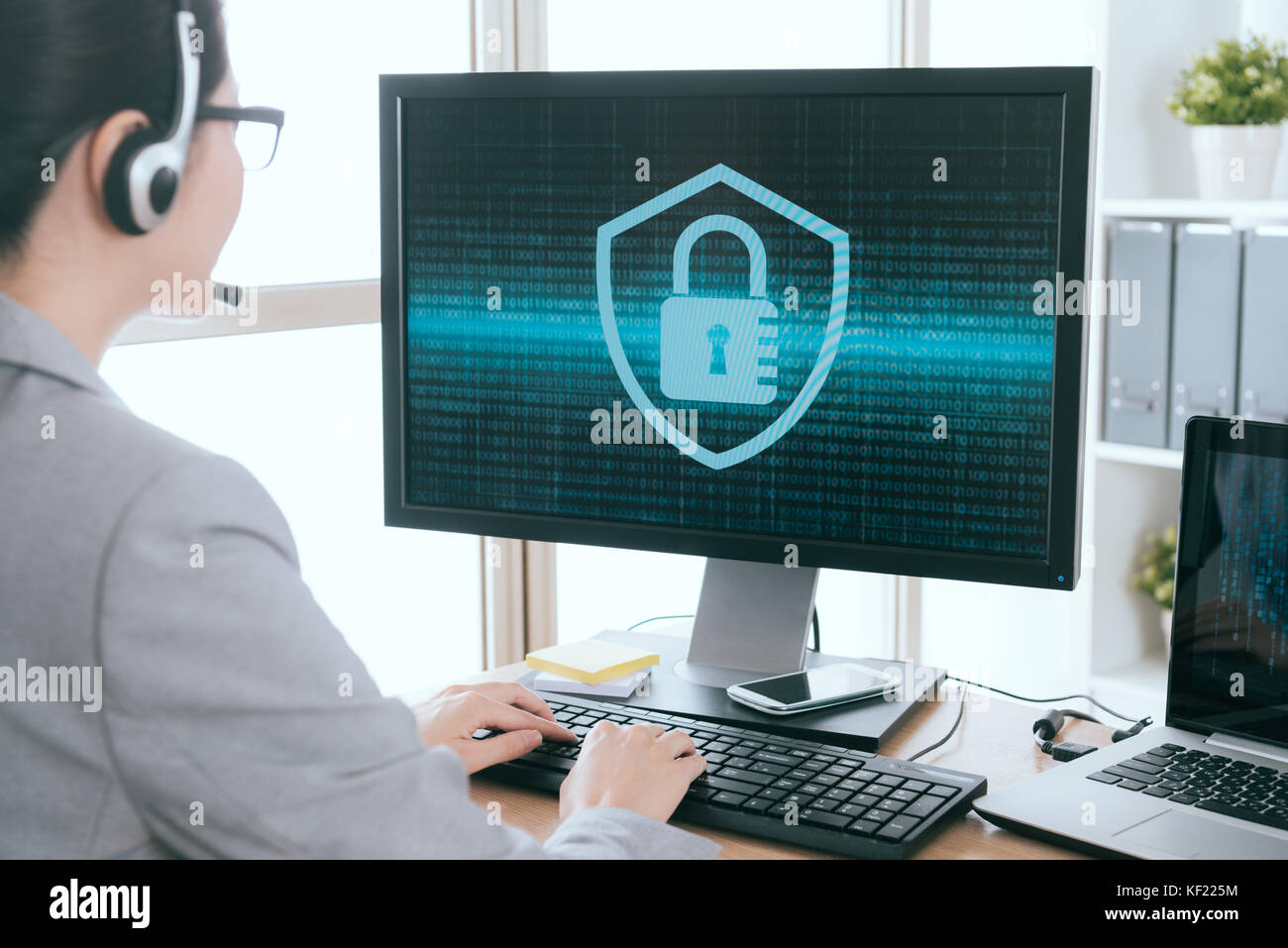 back view of young business woman operator talking online with customer ...