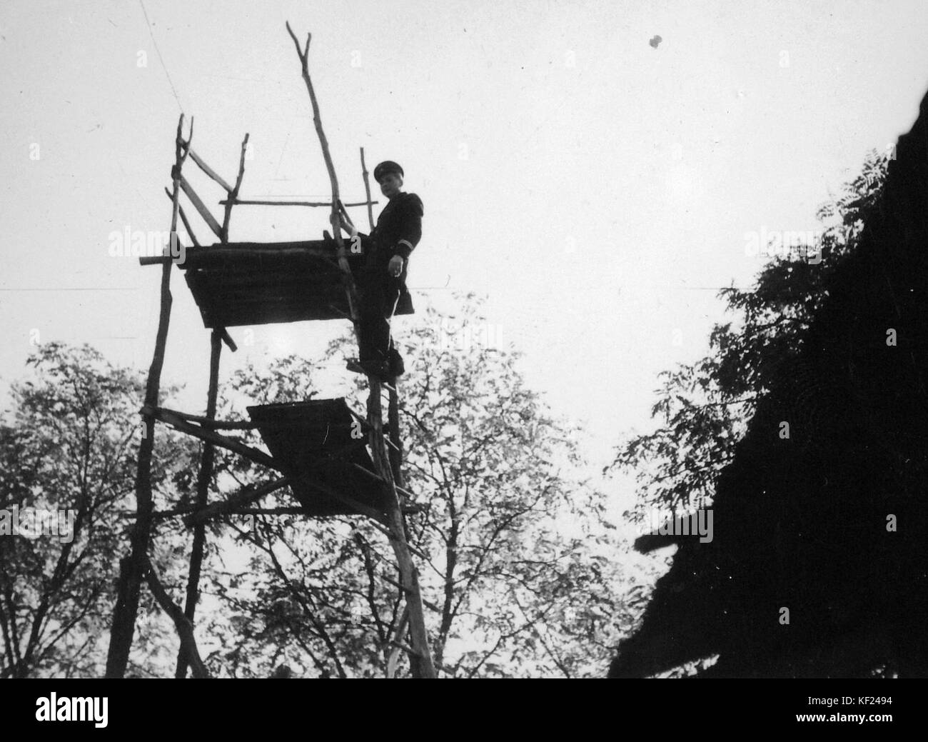This image depicts a hunter in an ambush, likely showing a historical ...