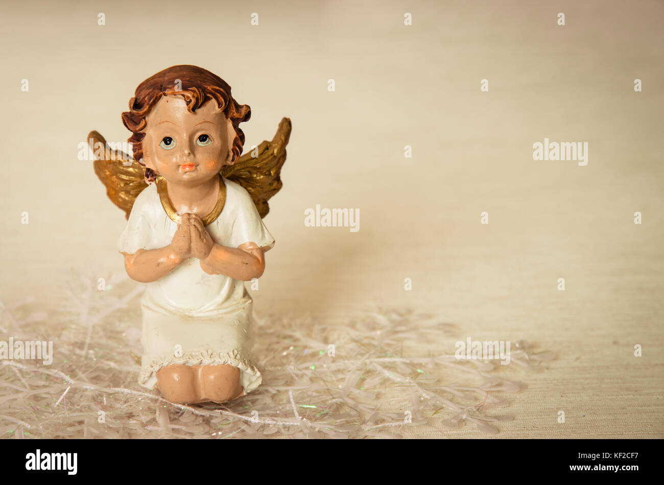 innocent praying angel with playing gesture Stock Photo - Alamy