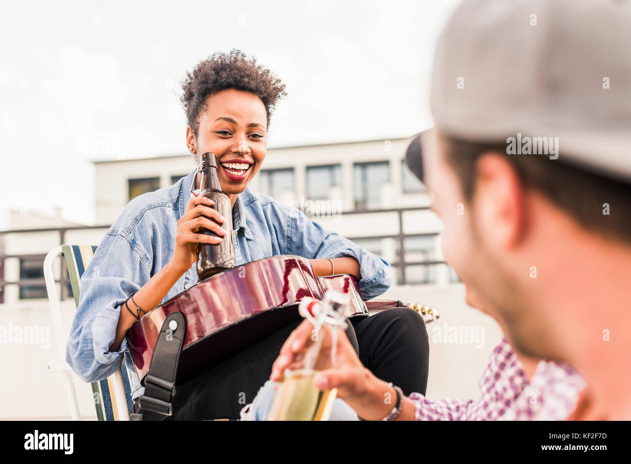 Three friends having a rooftop party Stock Photo - Alamy
