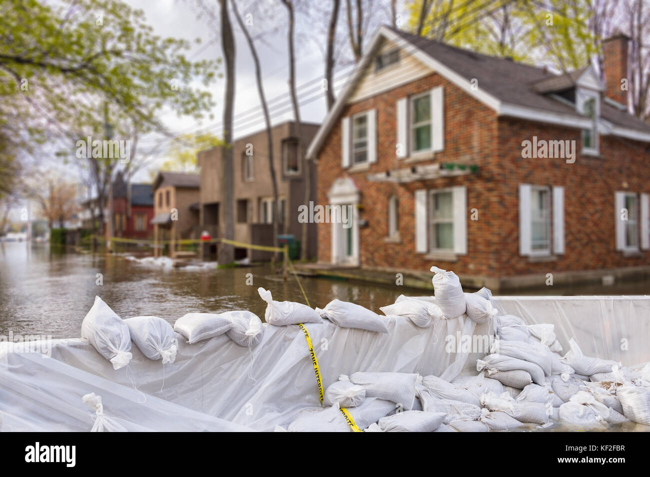 Flood Protection Sandbags with flooded homes in the background (Montage ...