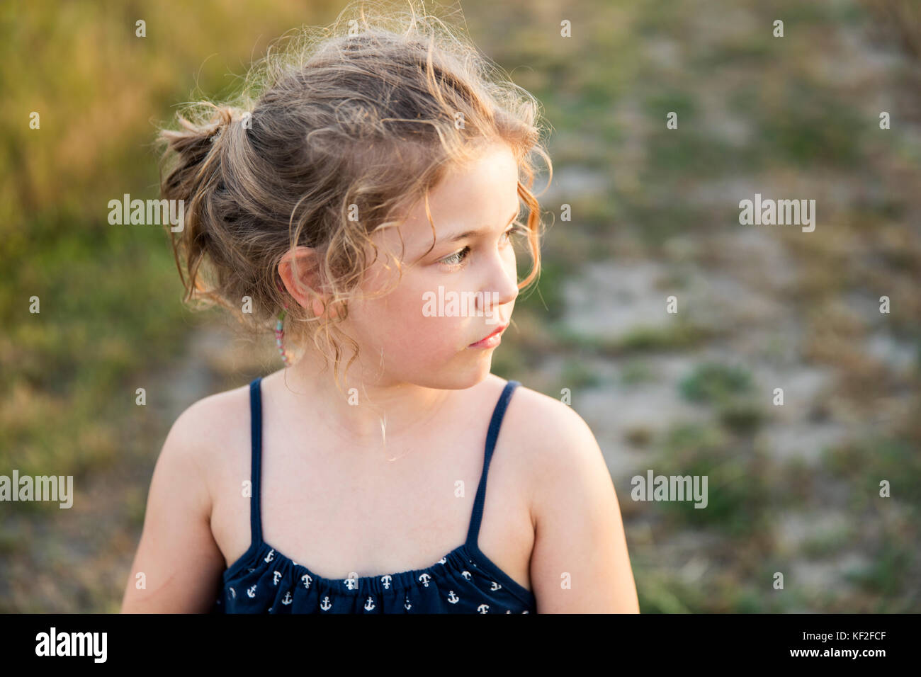 Serious girl outdoors looking sideways Stock Photo - Alamy