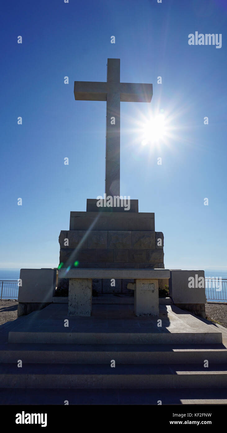 christian symbol against the sun with blue sky Stock Photo - Alamy