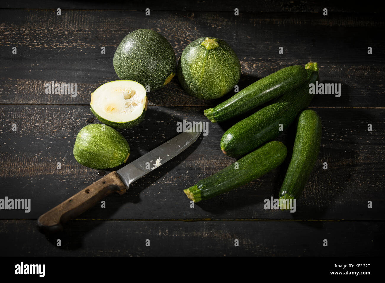 Eight ball squashes and courgettes on dark wood Stock Photo - Alamy