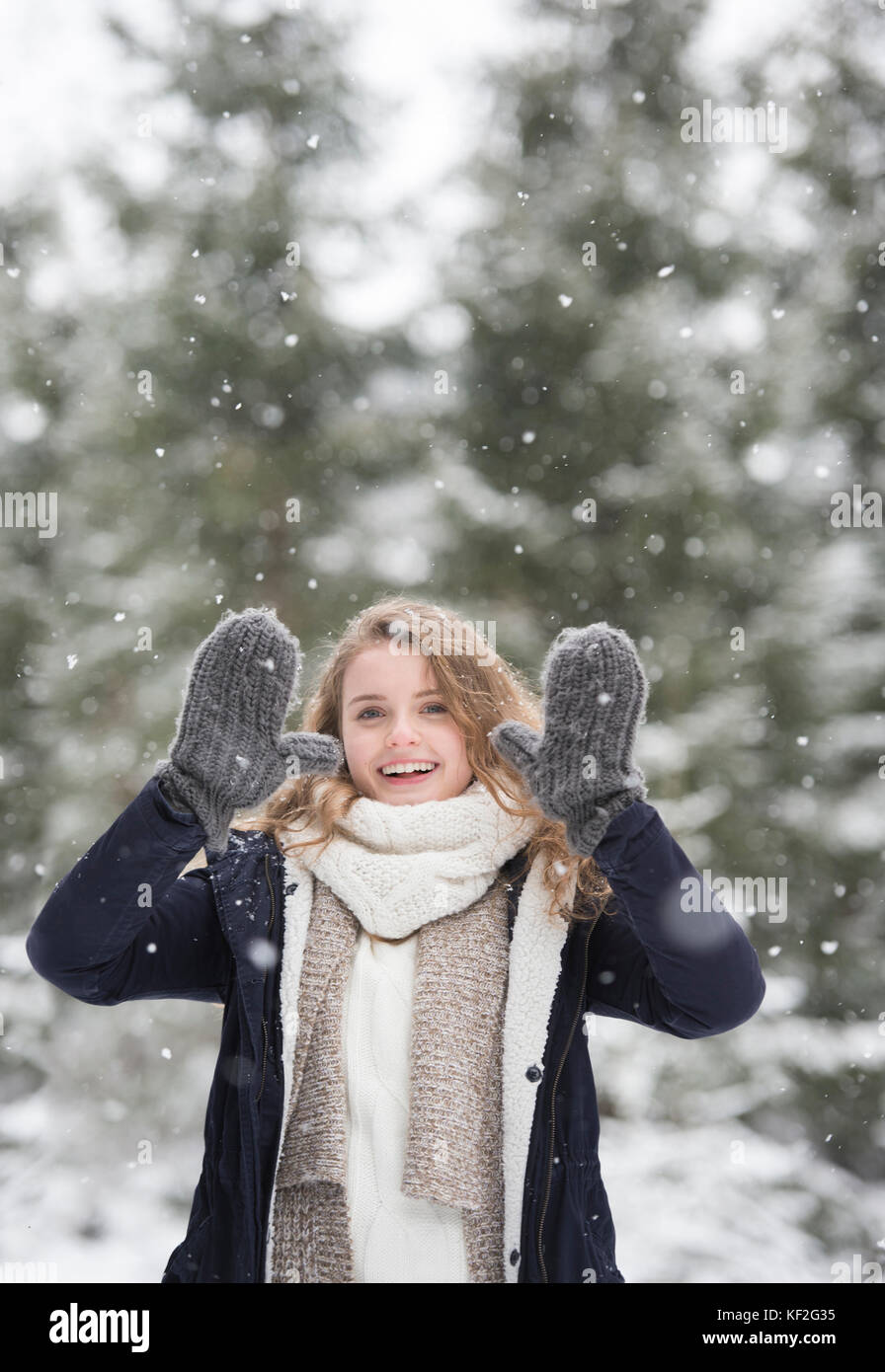 Portrait of happy young woman at snowfall in nature Stock Photo - Alamy