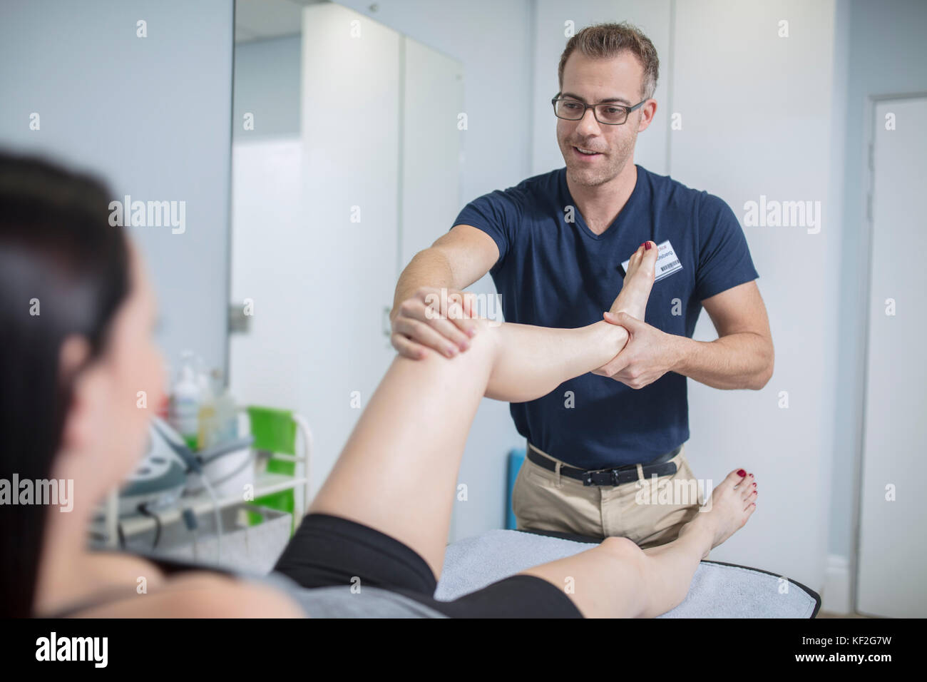 Woman receiving treatment from physio Stock Photo - Alamy