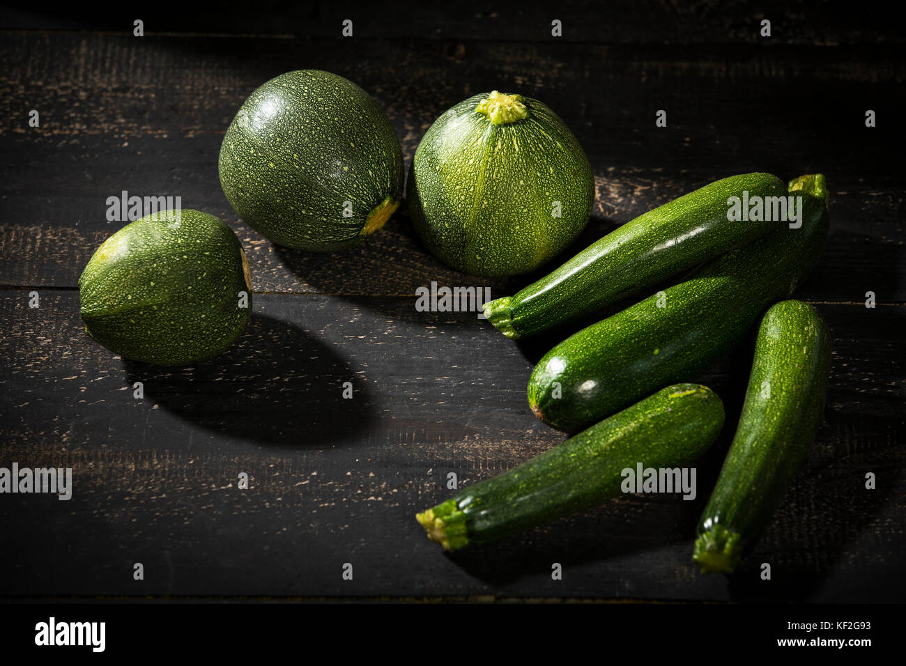 Eight ball squashes and courgettes on dark wood Stock Photo - Alamy