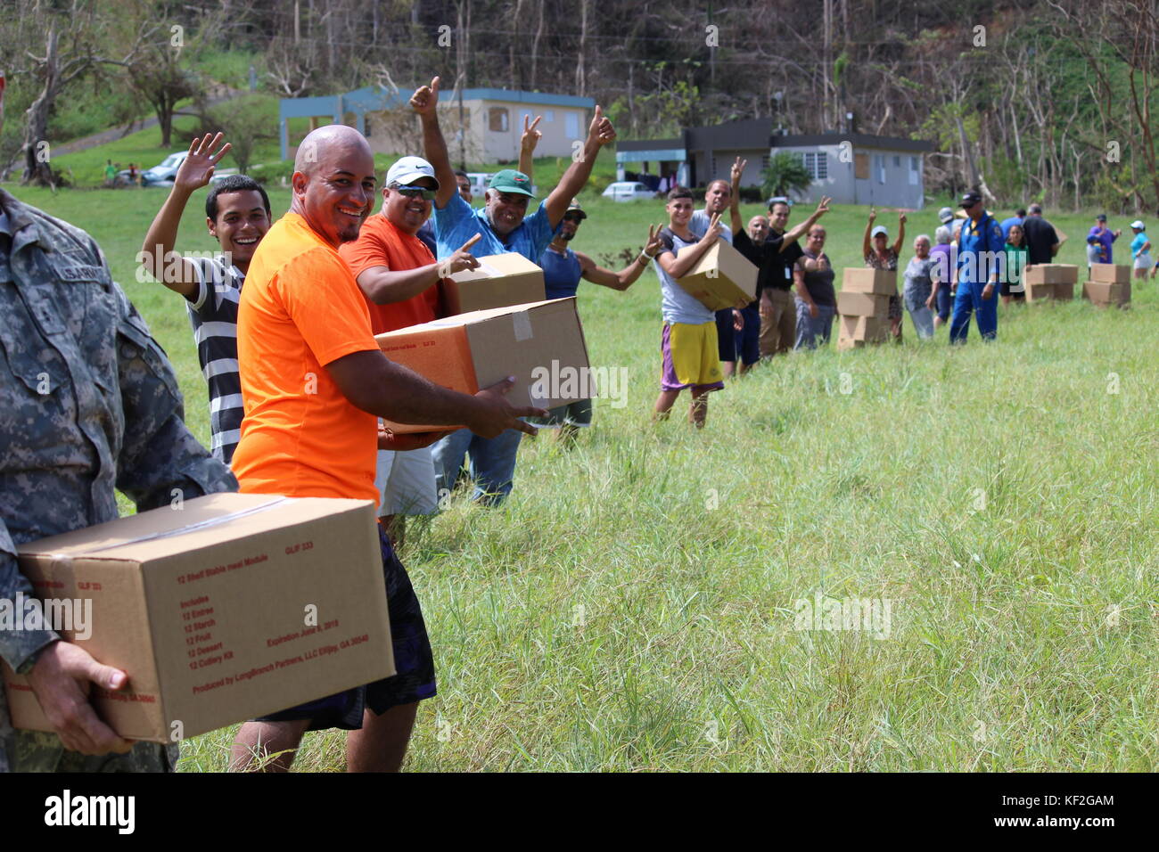 U.S. Army soldiers and local volunteers unload emergency supplies from ...