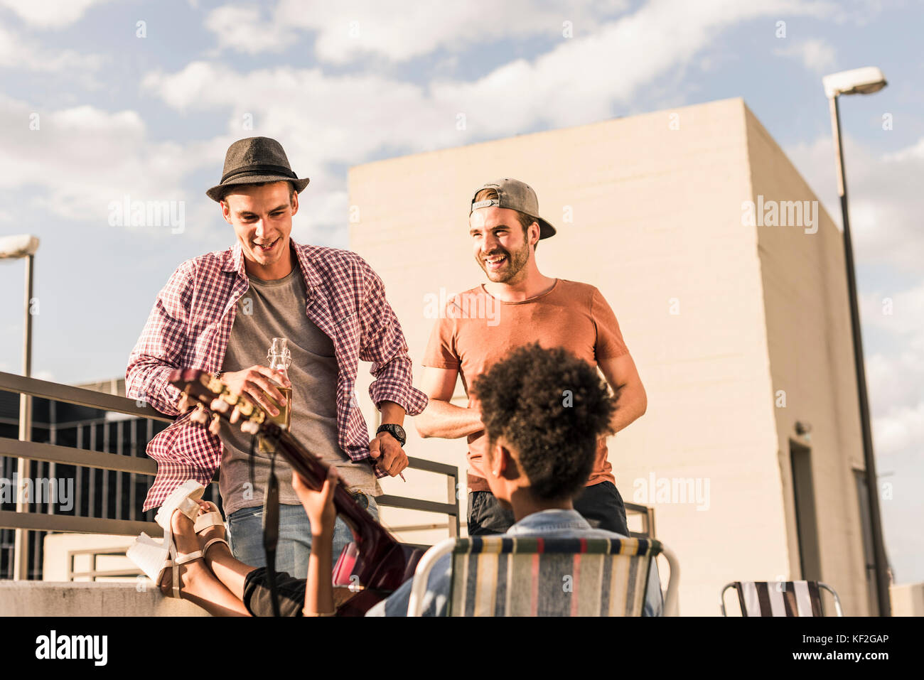 Three friends having a rooftop party Stock Photo - Alamy