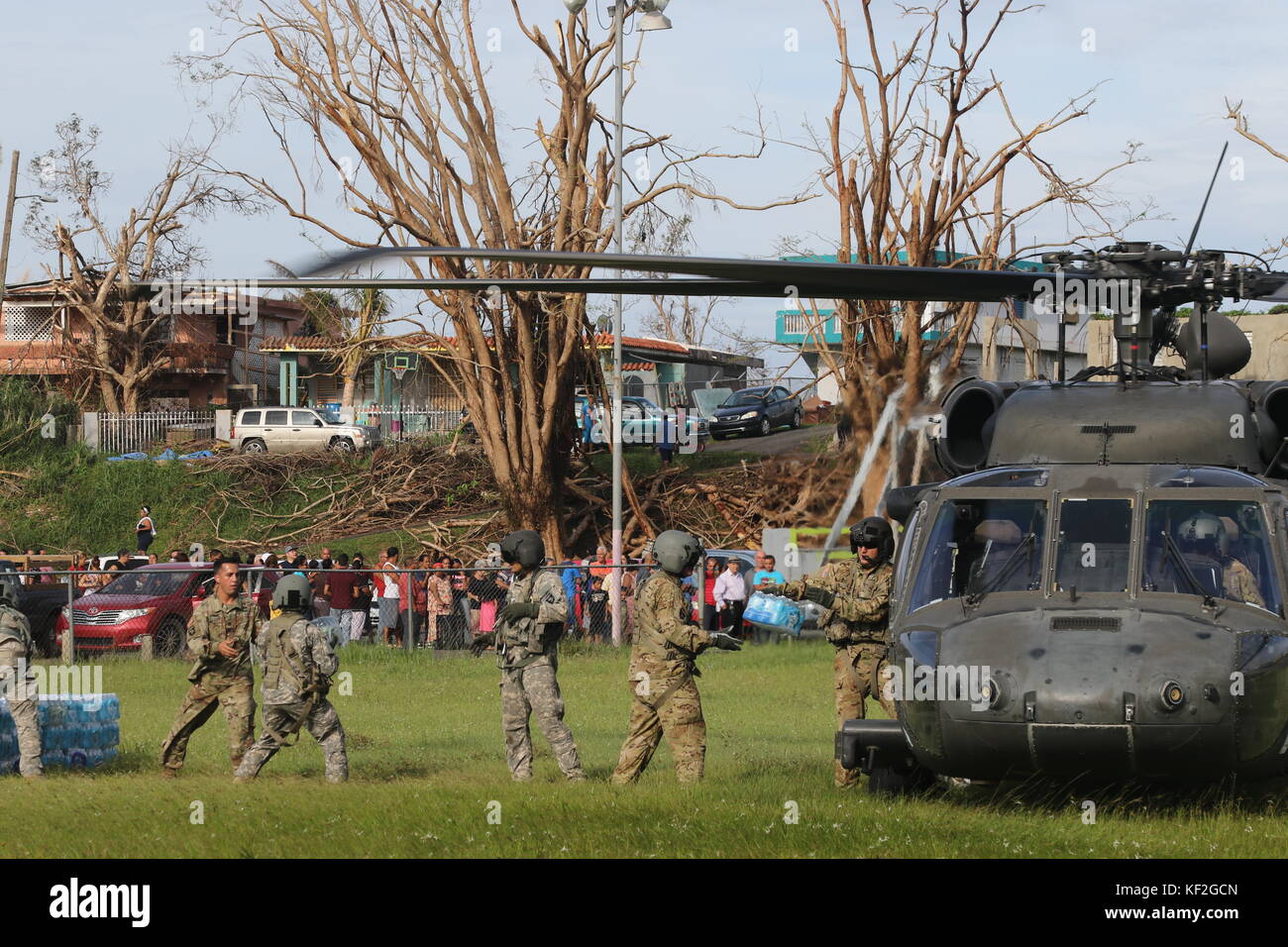 U.S. Army soldiers unload water and emergency supplies from a Blackhawk ...