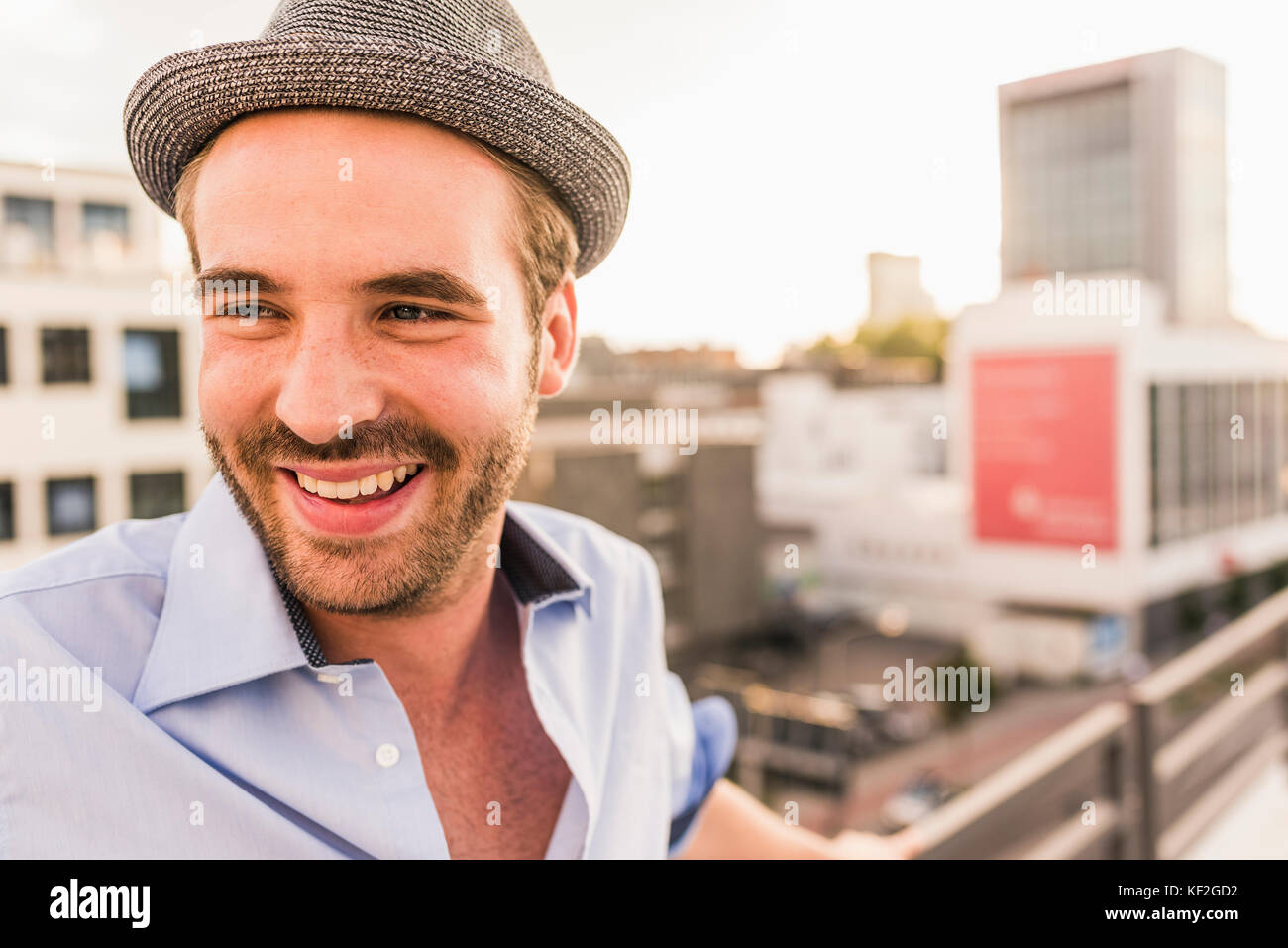 Portrait of happy young man on rooftop Stock Photo - Alamy