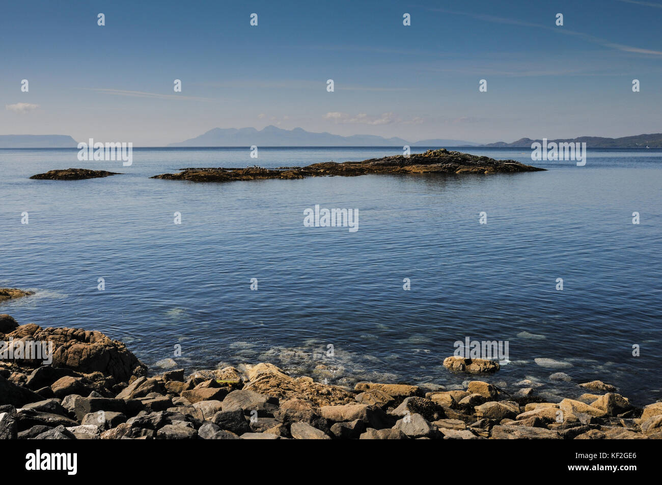 Sunny summer view across the sea from the Scottish West Highland coast ...