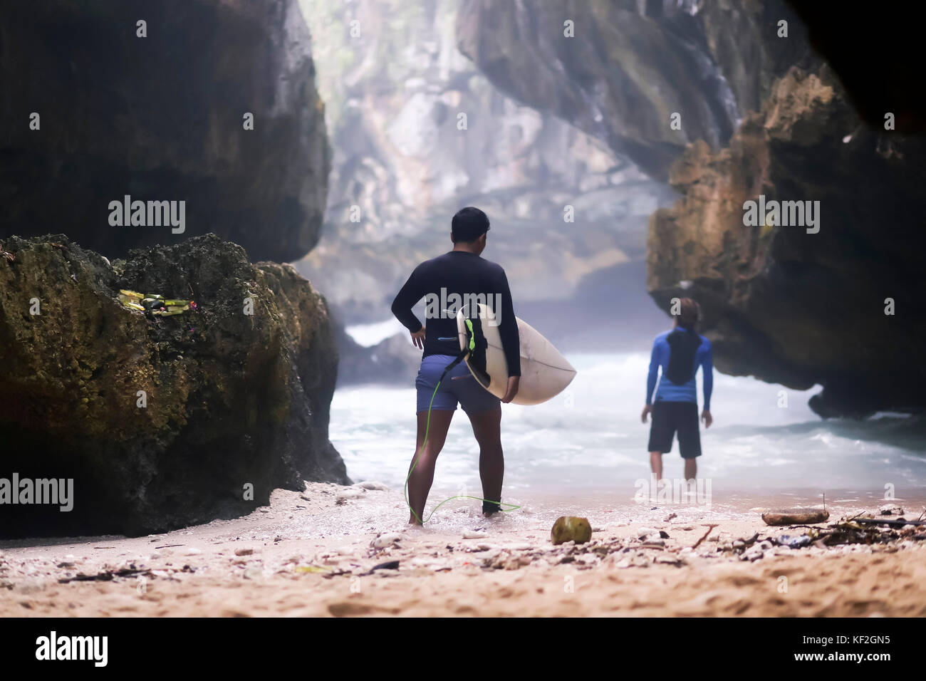 Indonesia, Bali, back view of surfer carrying surfboard Stock Photo - Alamy