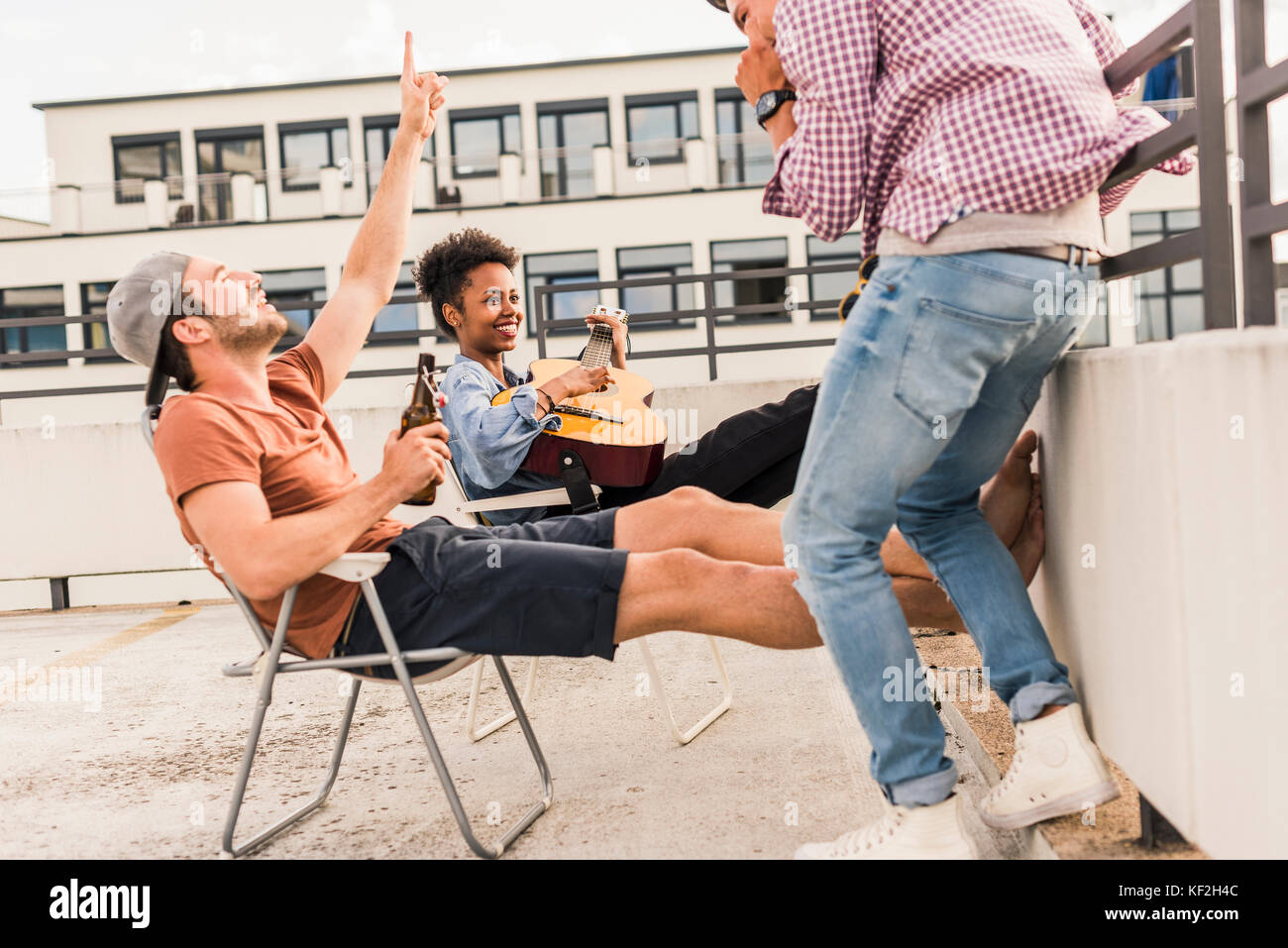 Three friends having a rooftop party Stock Photo - Alamy