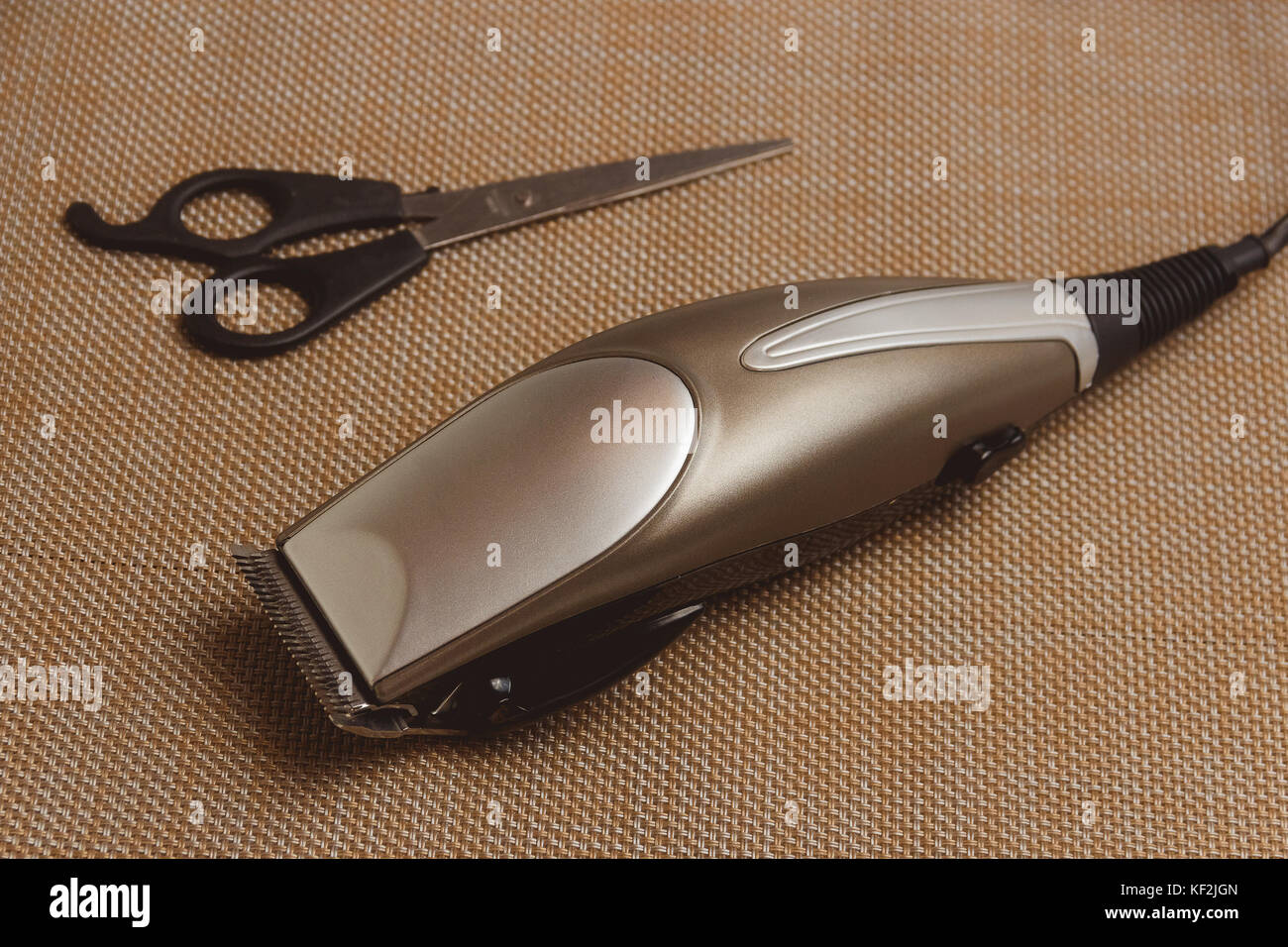 Stylish Professional Hair Clippers, accessories on brown background ...