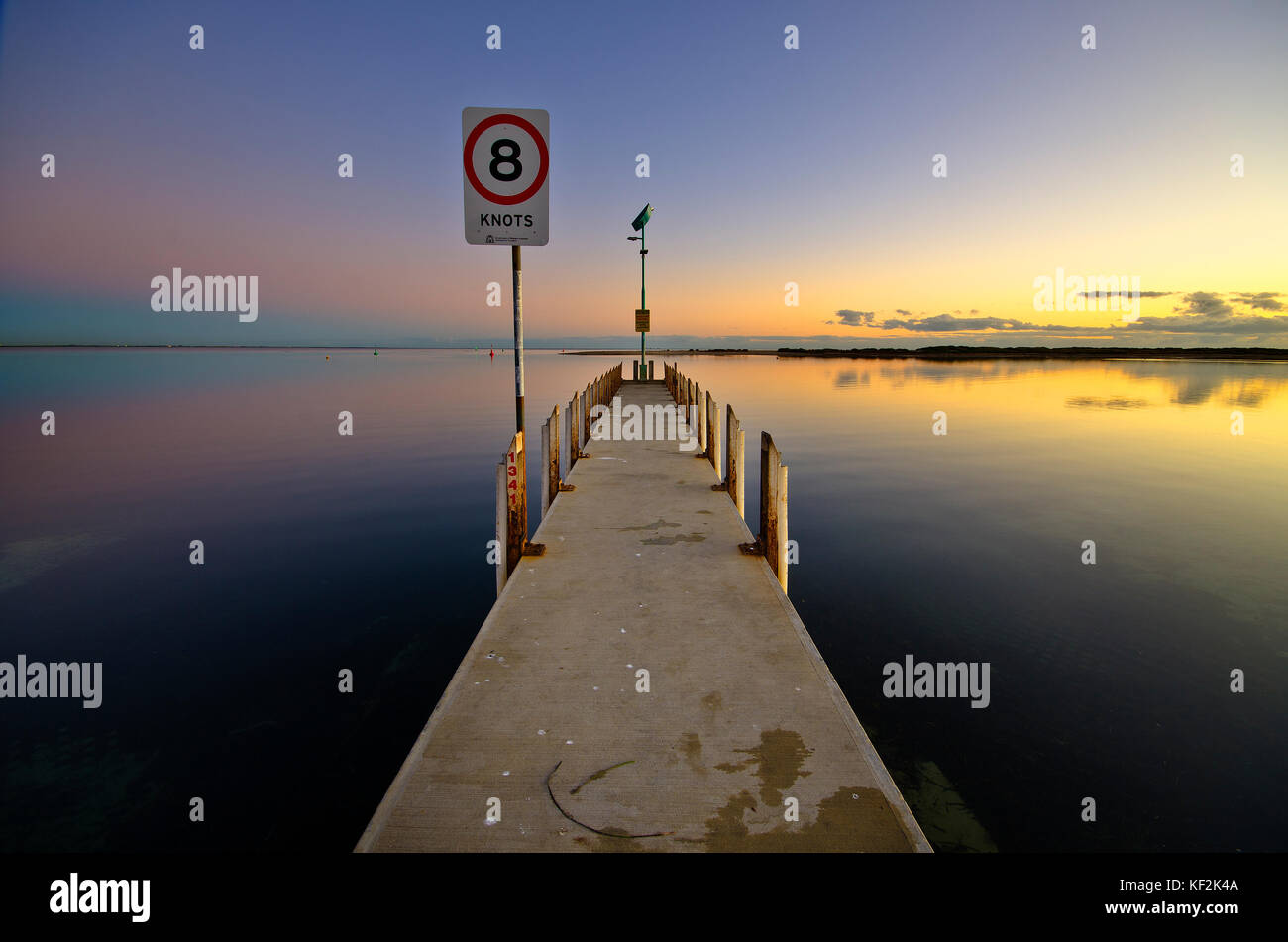 Concrete jetty with speed limit sign in early morning Stock Photo - Alamy