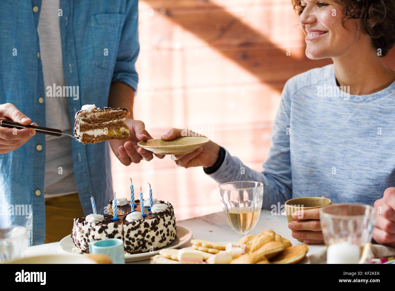 Sharing birthday cake Stock Photo - Alamy