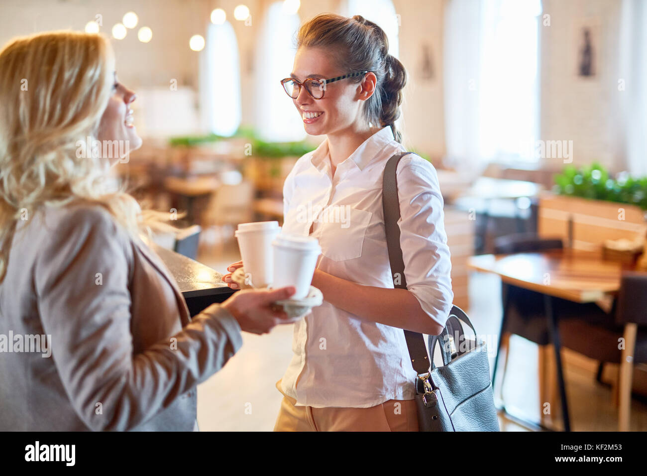 Chatting Animatedly with Coworker Stock Photo - Alamy