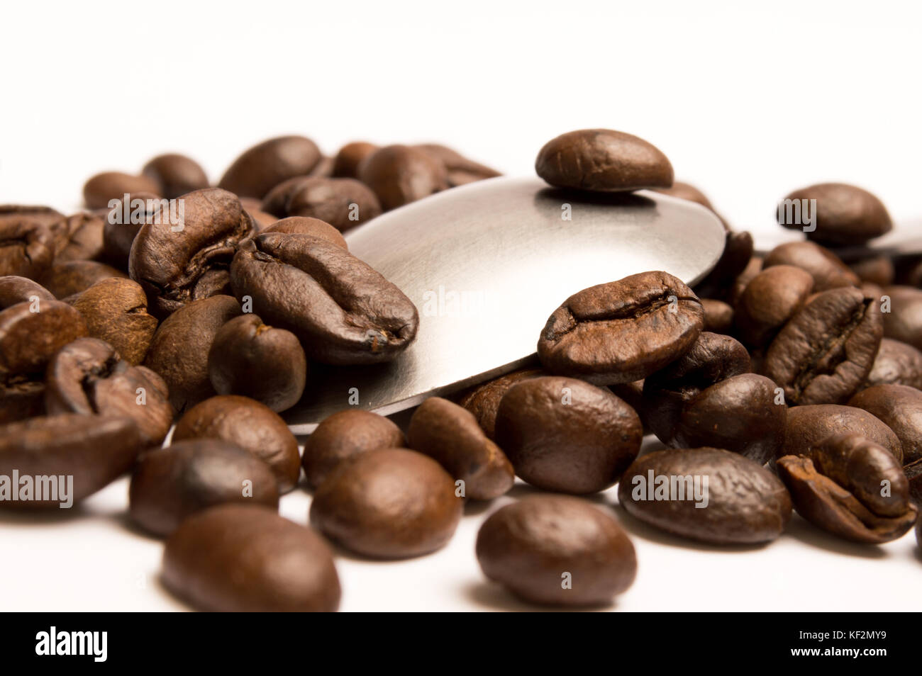 spoon with coffee beans Stock Photo - Alamy