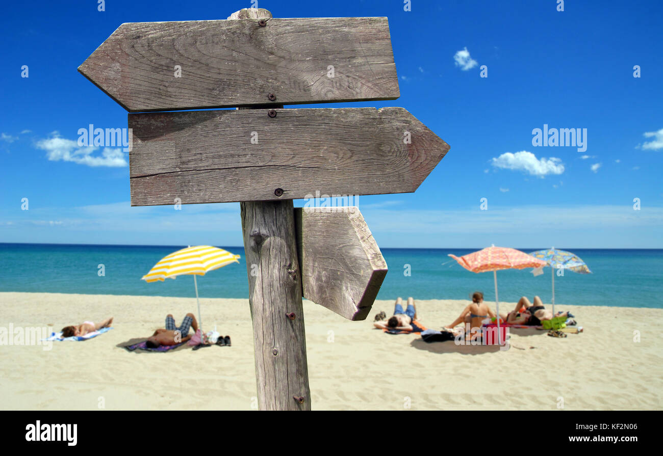 Holiday destination. Signs of direction on the beach Stock Photo - Alamy