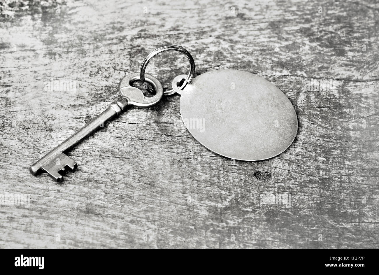 old key on ring on wooden background Stock Photo - Alamy