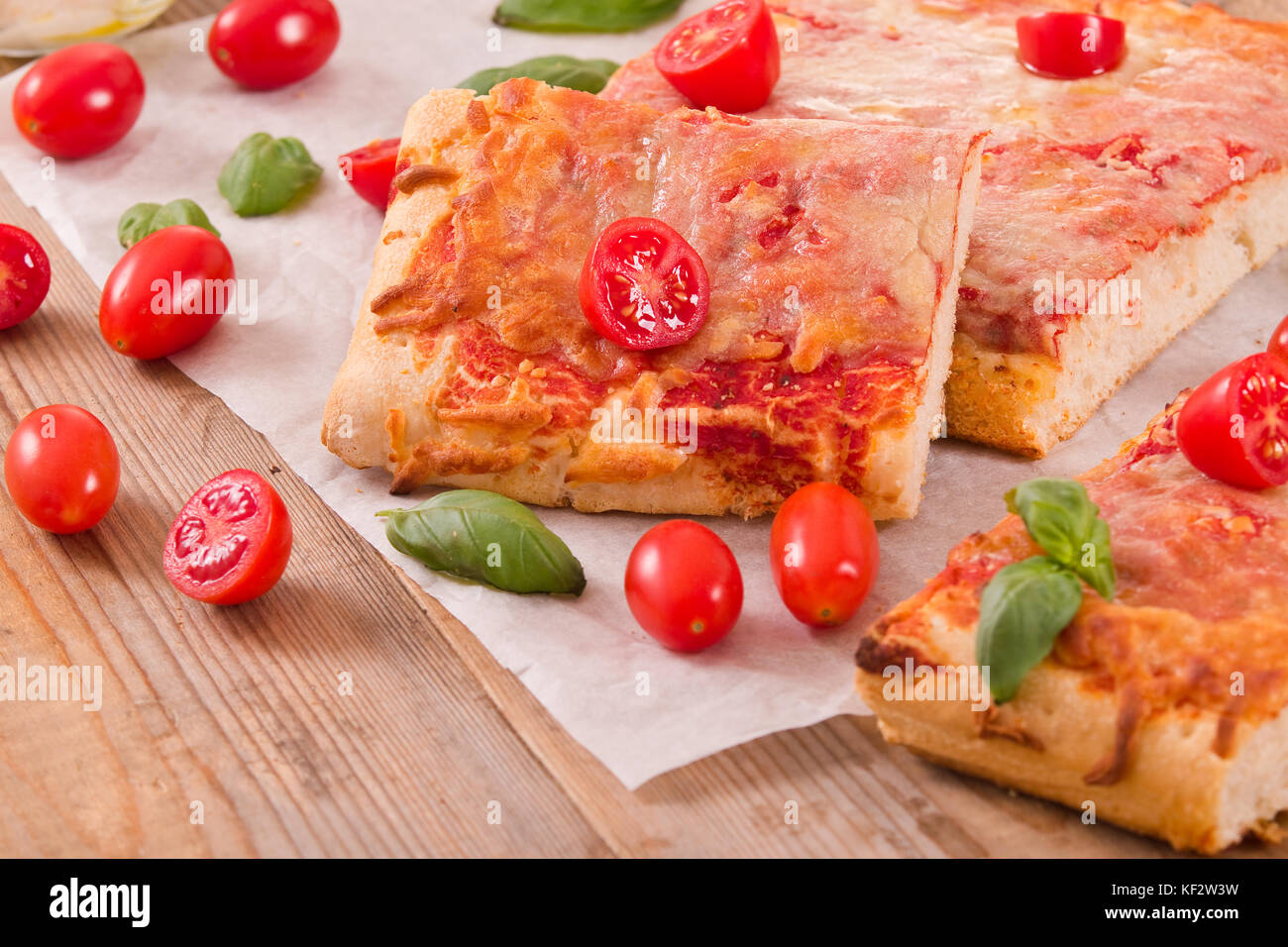 Italian pizza with cheese, tomatoes and fresh basil Stock Photo - Alamy