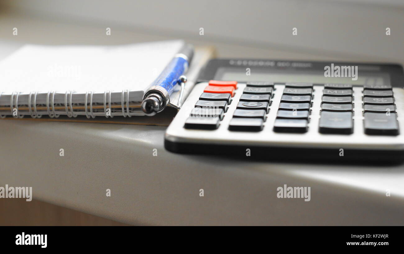 Calculator, pen and paper notepad Counting on the calculator and record ...