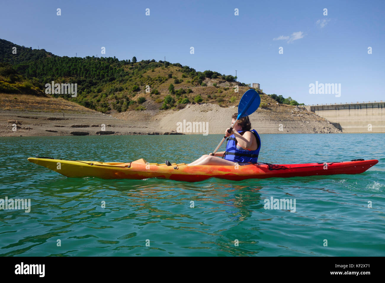 Young woman with a colorful kayak in a dam Stock Photo - Alamy
