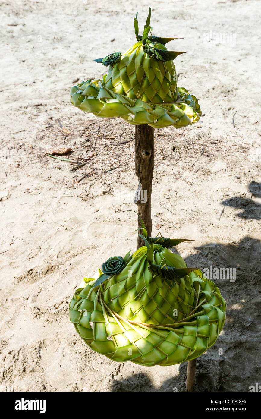 close up of a pair of hats made from palm leaves on a beach in Costa ...
