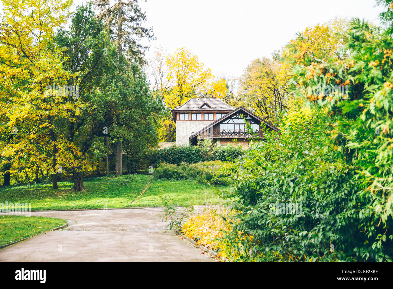 Nice autumnal scene with house in trees Stock Photo - Alamy