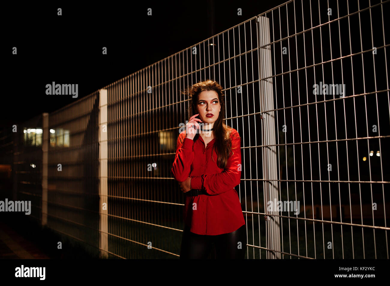 Black girl in red shirt and bright make-up on night street outdoor ...