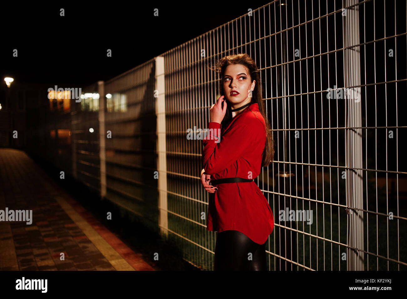 Black girl in red shirt and bright make-up on night street outdoor ...