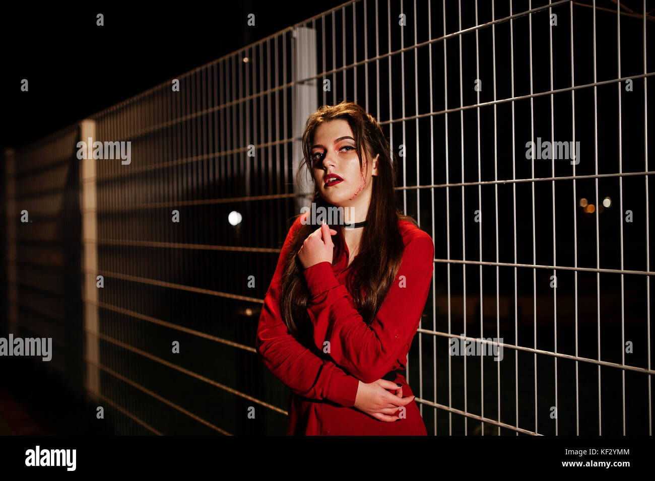 Black girl in red shirt and bright make-up on night street outdoor ...