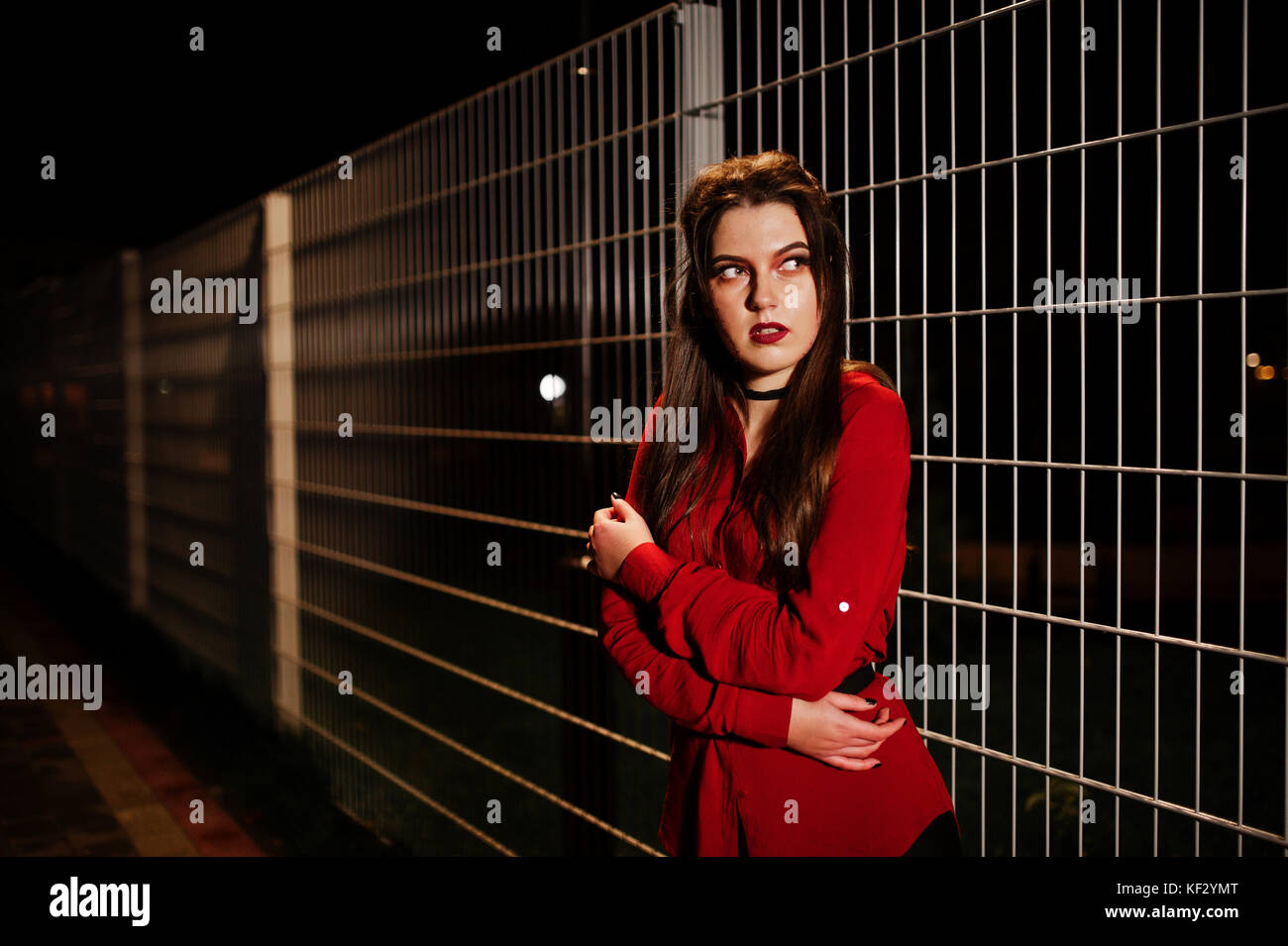 Black girl in red shirt and bright make-up on night street outdoor ...