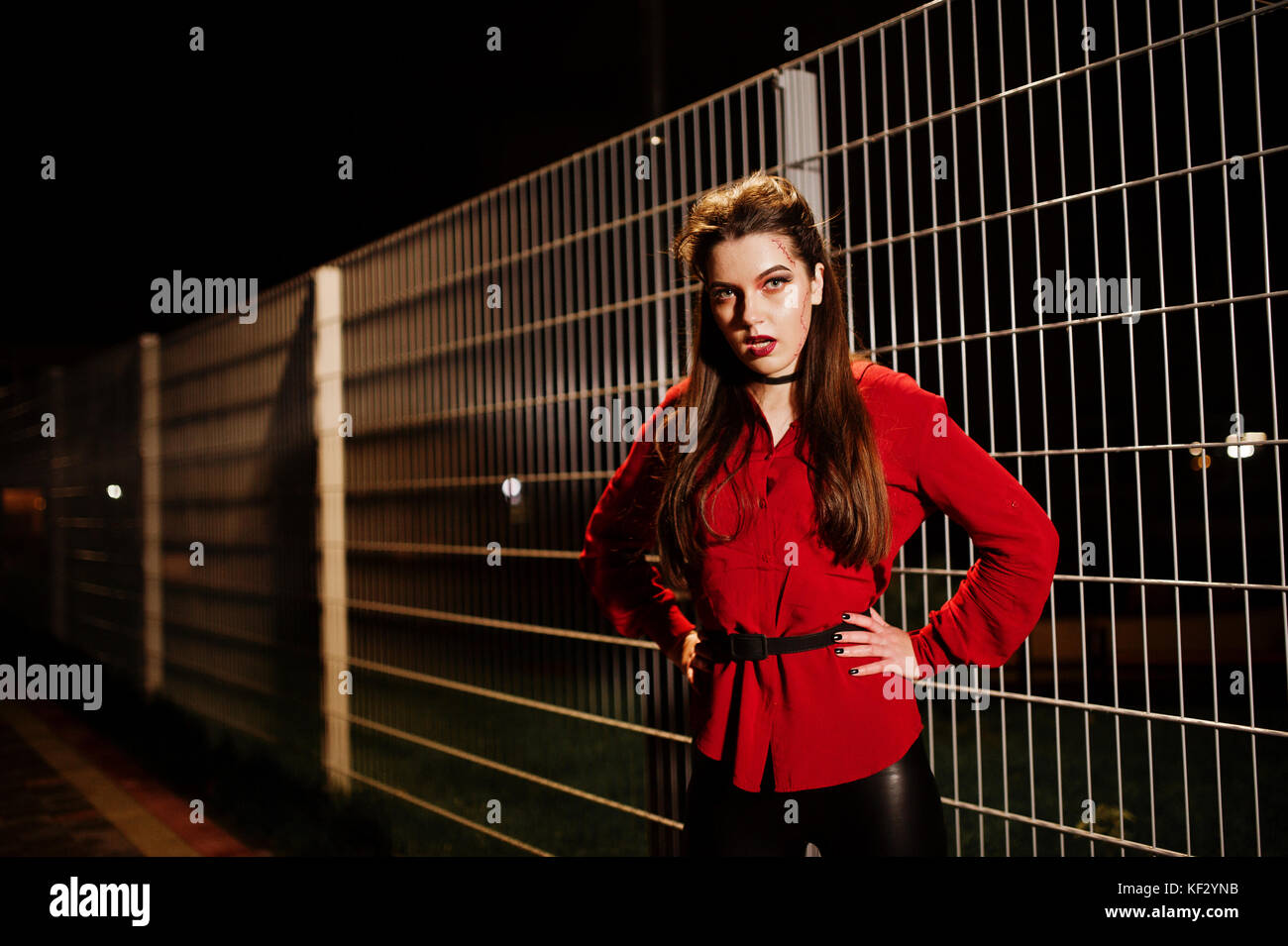 Black girl in red shirt and bright make-up on night street outdoor ...
