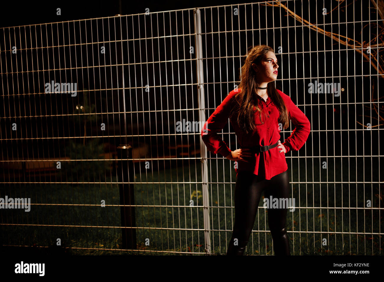 Black girl in red shirt and bright make-up on night street outdoor ...