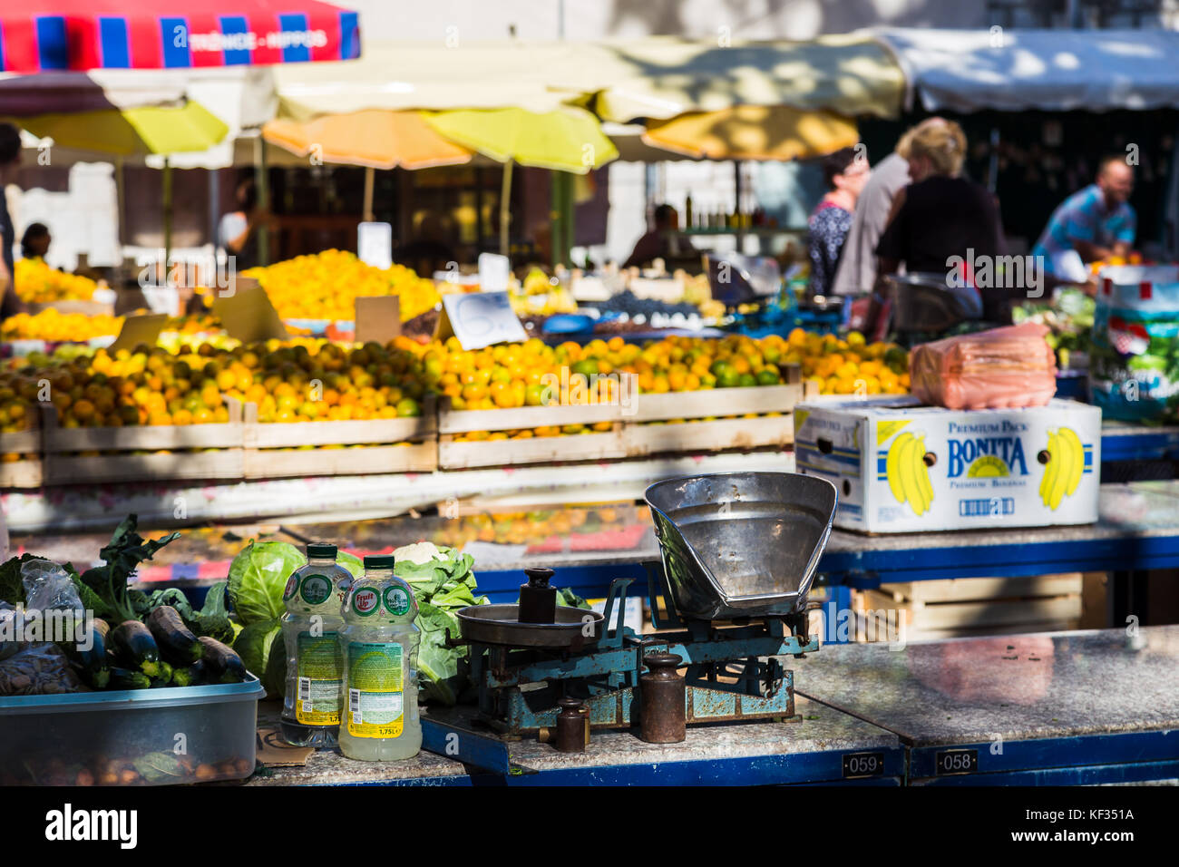 Traditional weighing scales pictured on the end of a stall on the green ...
