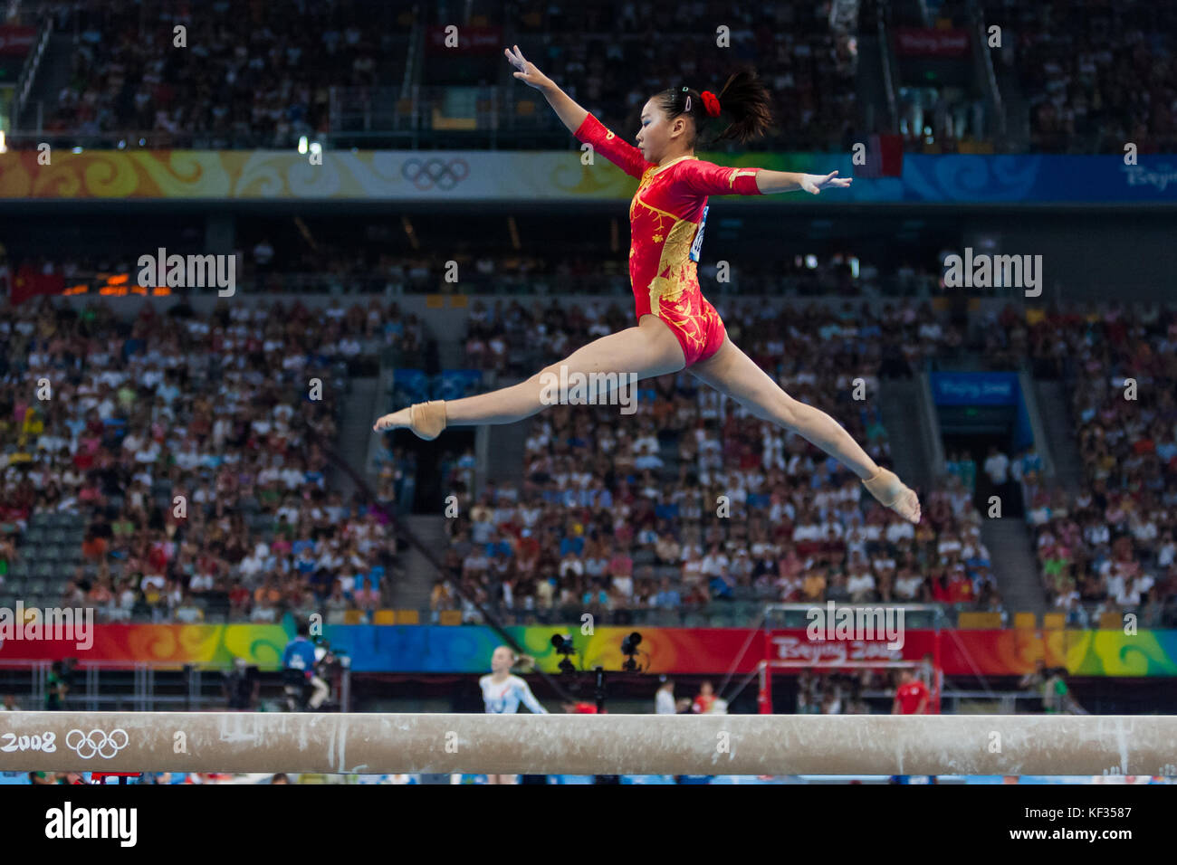 LinLin Deng (CHN) competing on the balance beam in the Women Team Event ...