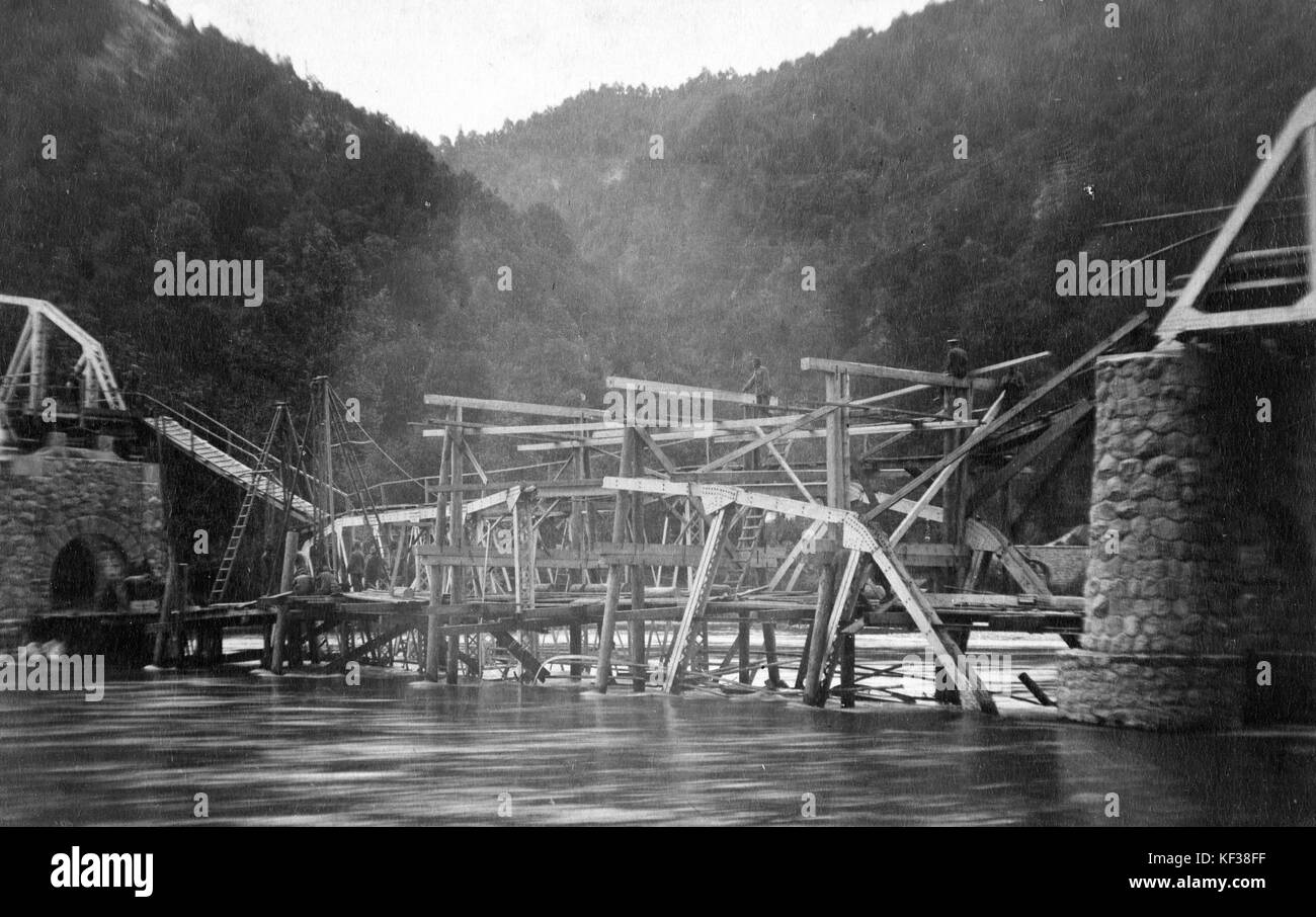 This image depicts the aftermath of war damage to a railway bridge. A ...