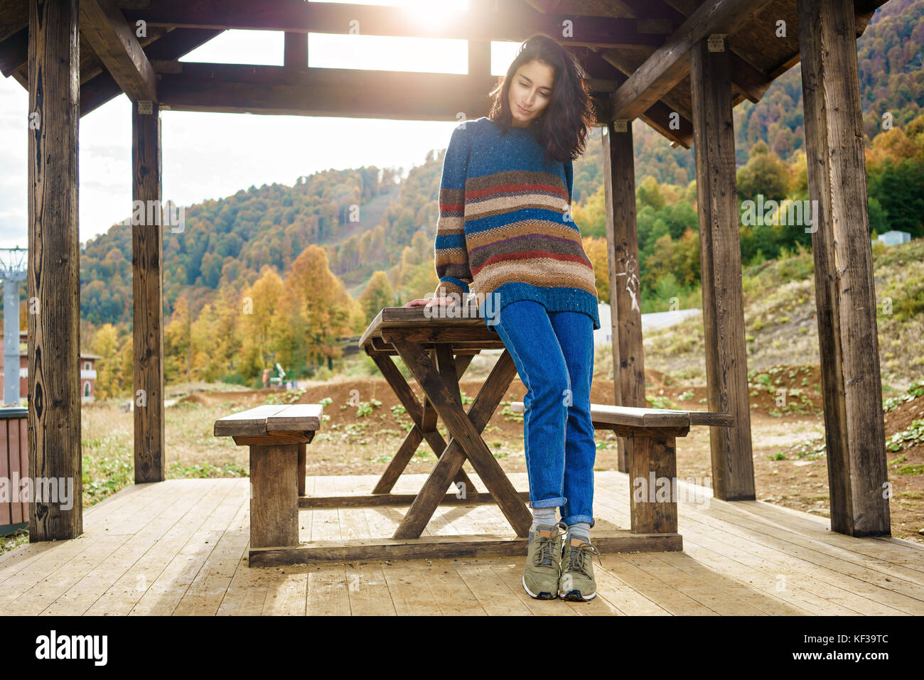 Girl travel in mountains alone. Spring weather, calm scene. Backpacker walking outdoors, view ...