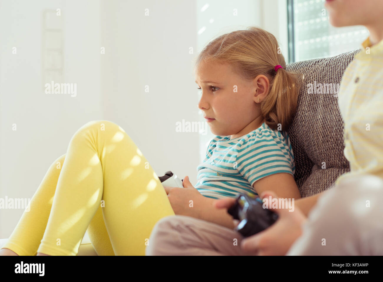 Two happy children playing video games with console at home Stock Photo ...