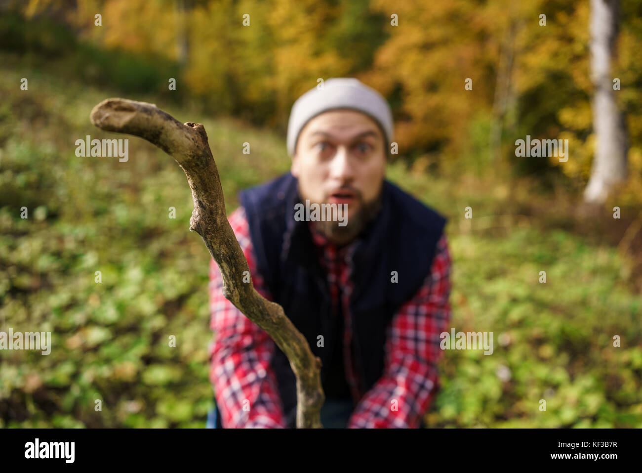 aggressive man with a stick in a hand Stock Photo - Alamy