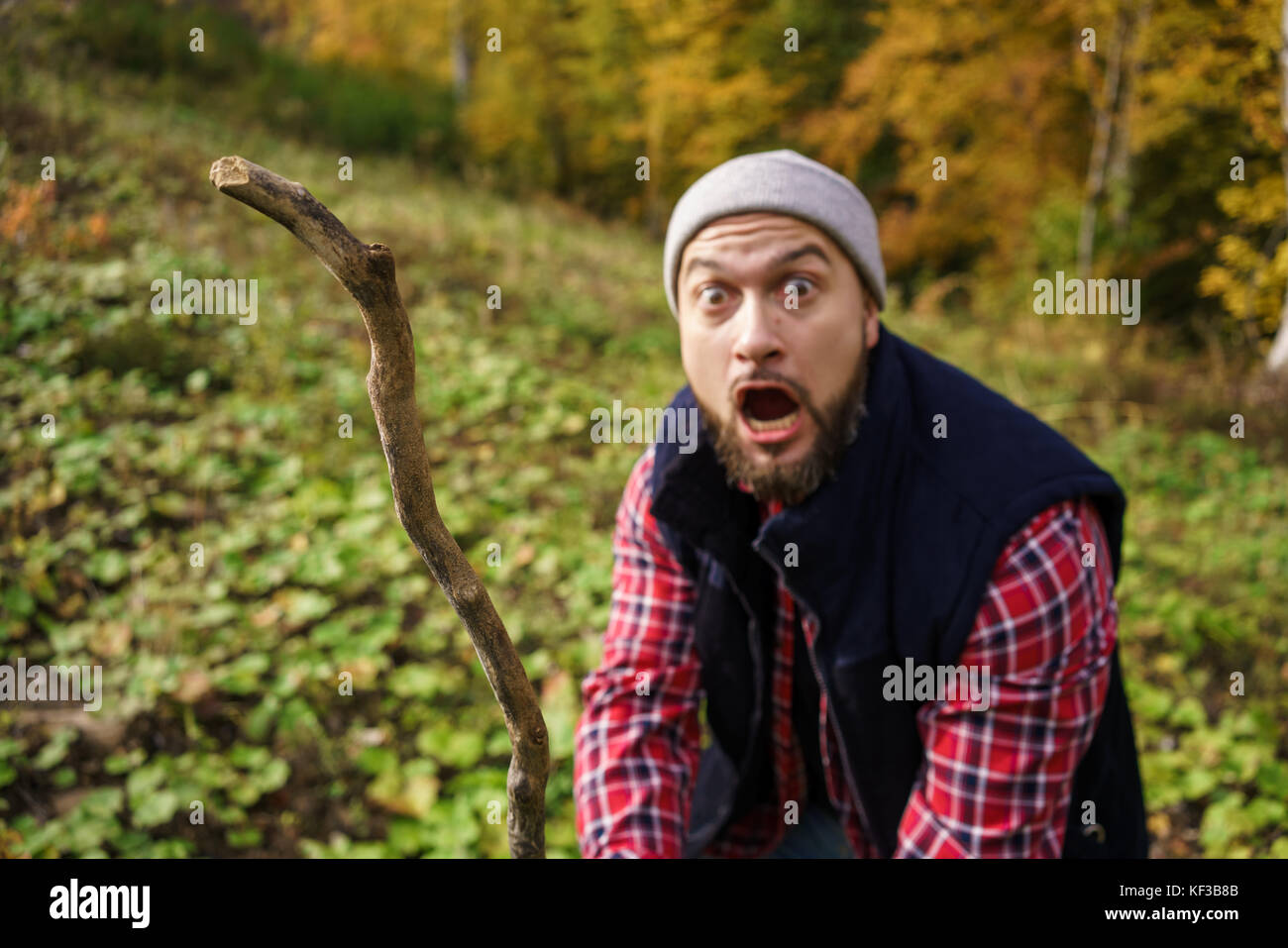 aggressive man with a stick in a hand Stock Photo - Alamy
