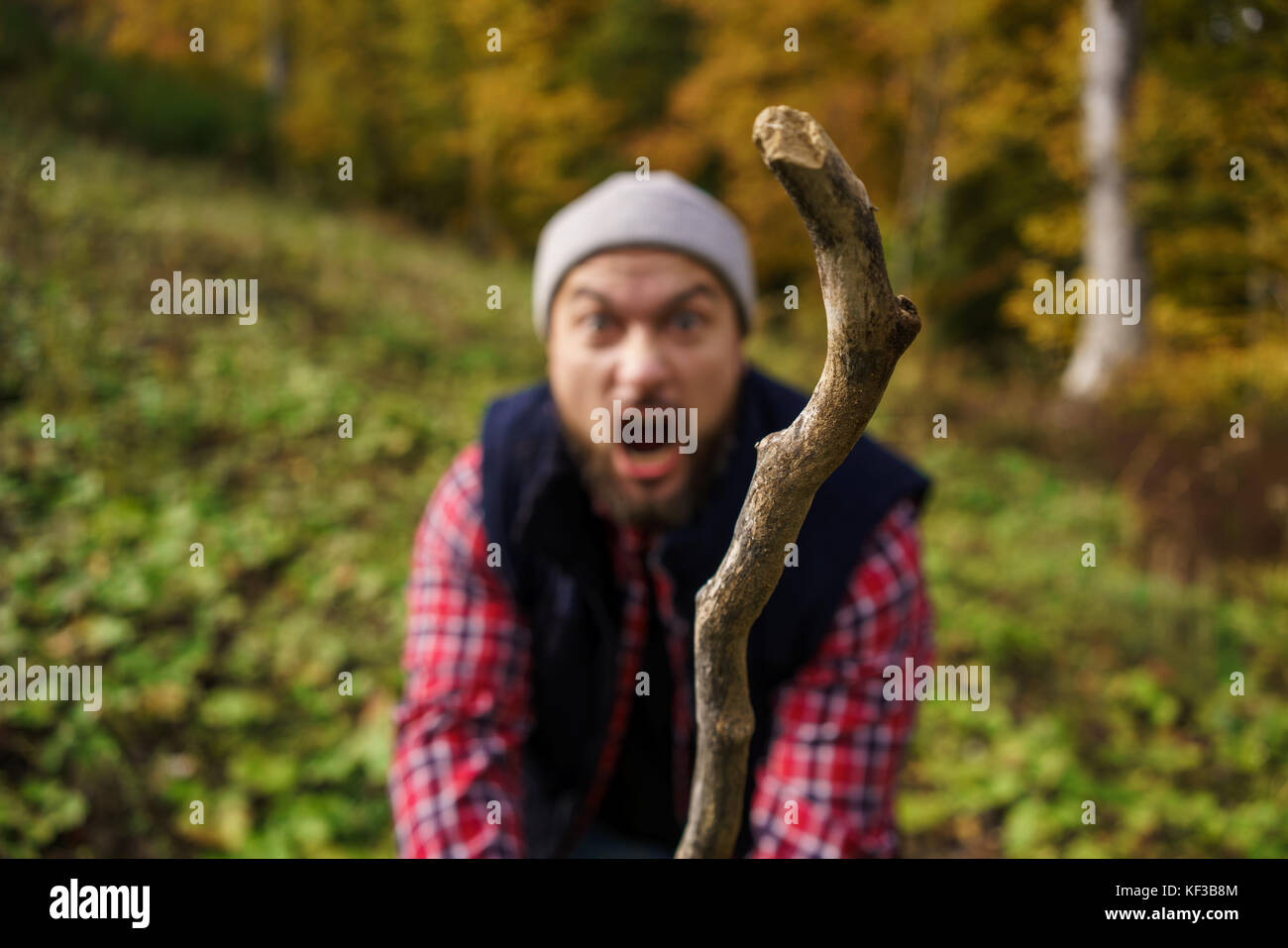 aggressive man with a stick in a hand Stock Photo - Alamy
