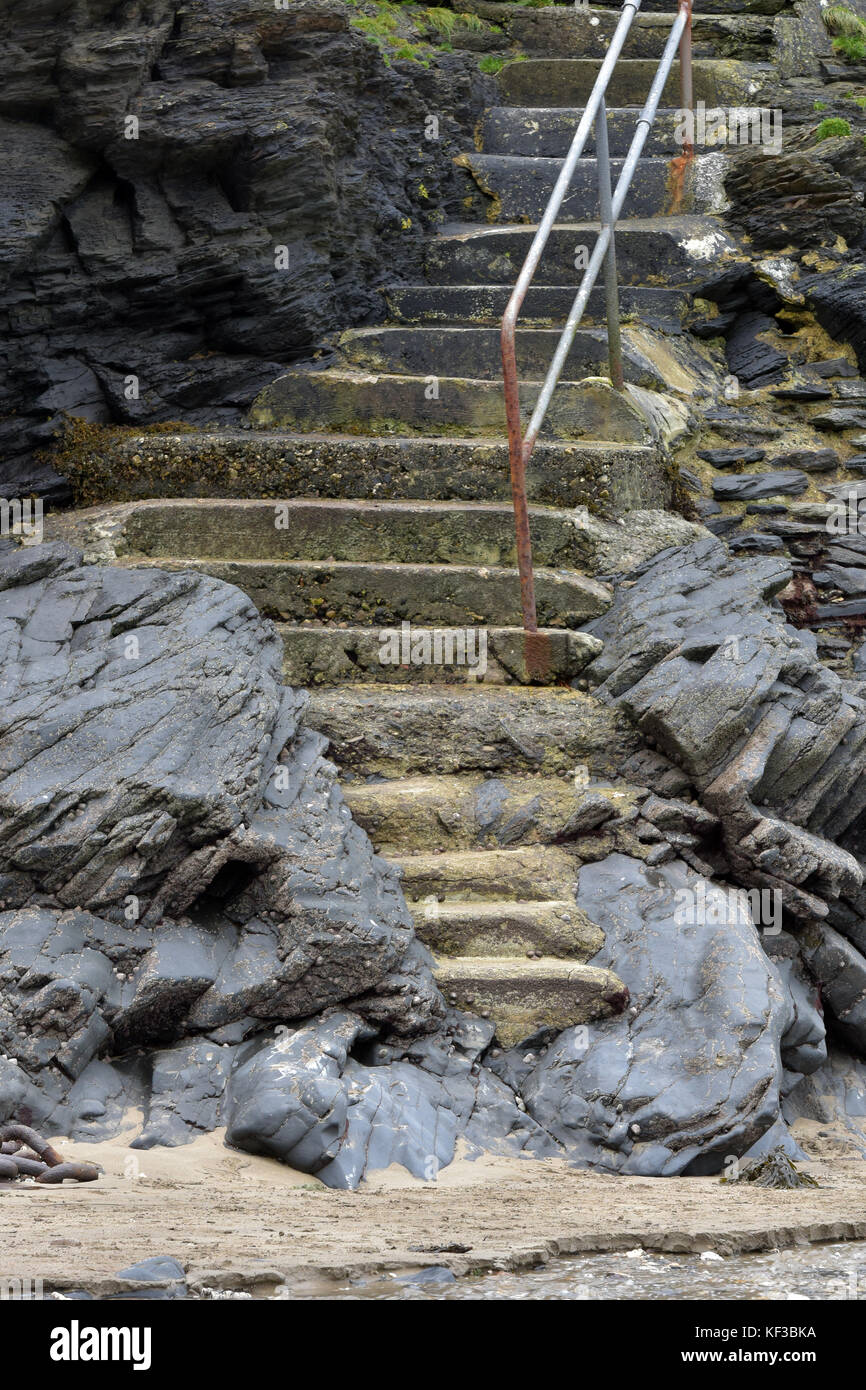 A set of steps or stairs on some rocks or a rocky beach or seashore ...