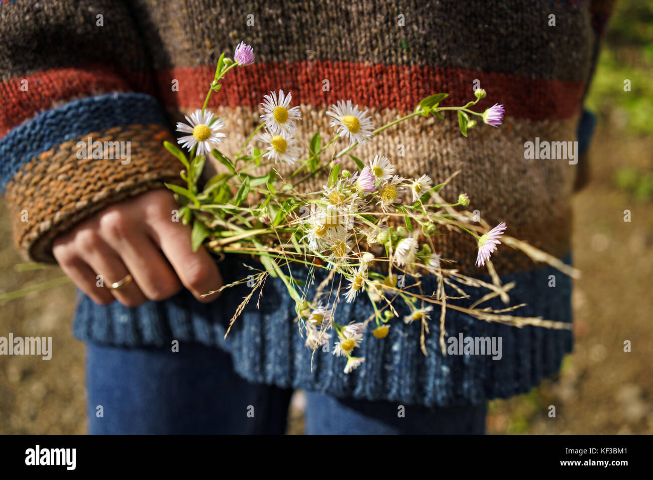 A man in jeans and sneakers is walking along a forest trail. Sunny ...