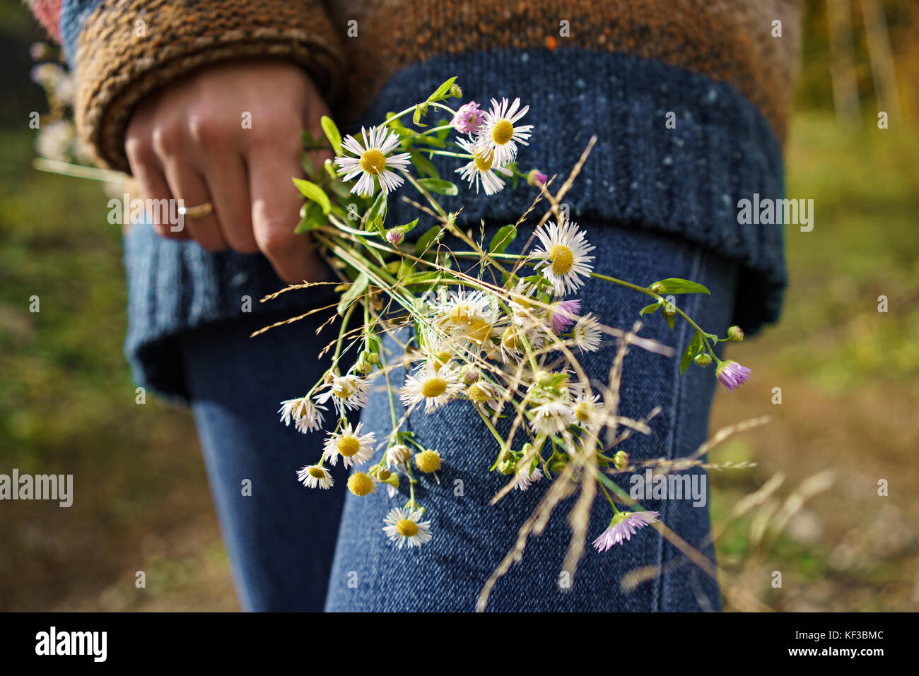 A man in jeans and sneakers is walking along a forest trail. Sunny ...