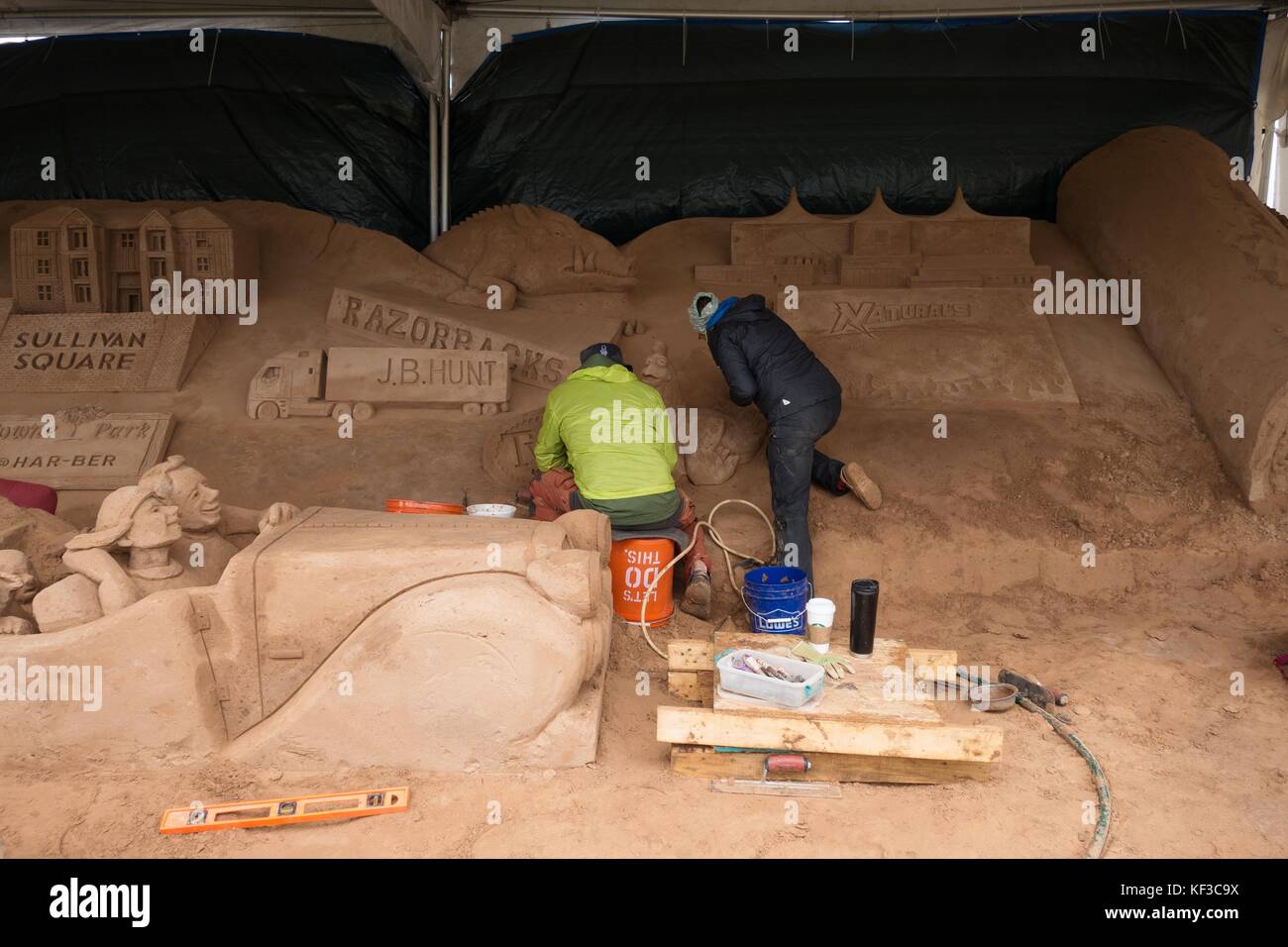 Two artists working on a sand sculpture installation in Bentonville ...