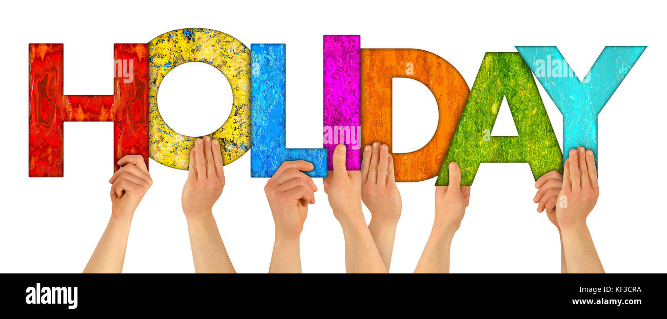 hands holding up colorful wood letter shaping the word holiday isolated ...