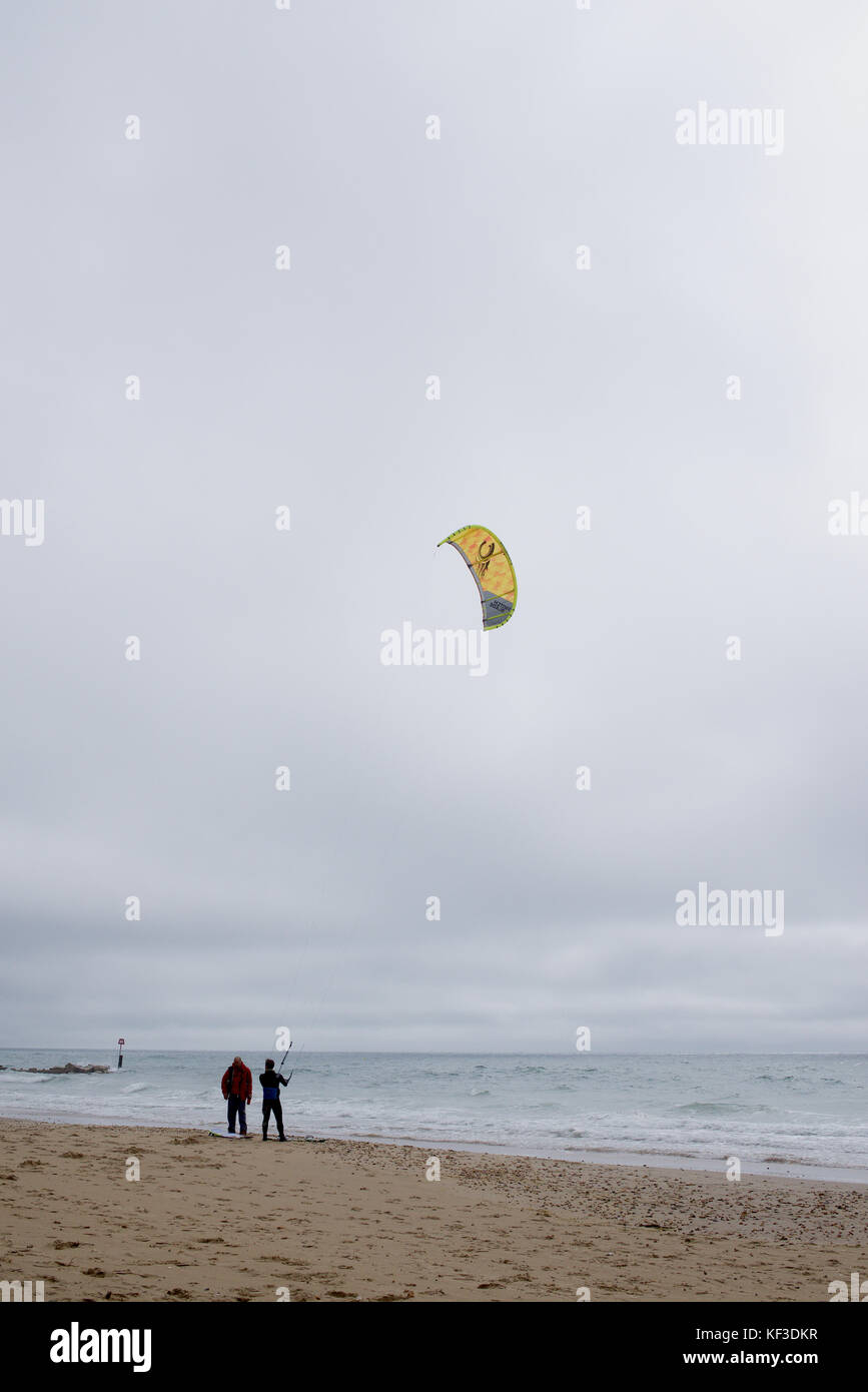 Wind-surfer getting ready on Bournemouth beach in typical English ...